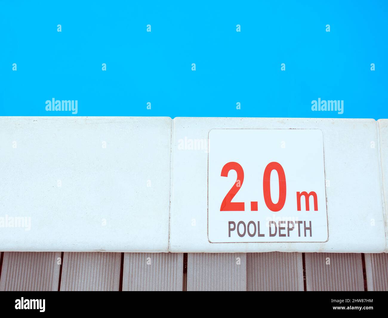The edge of the swimming pool with the table with information of the ...