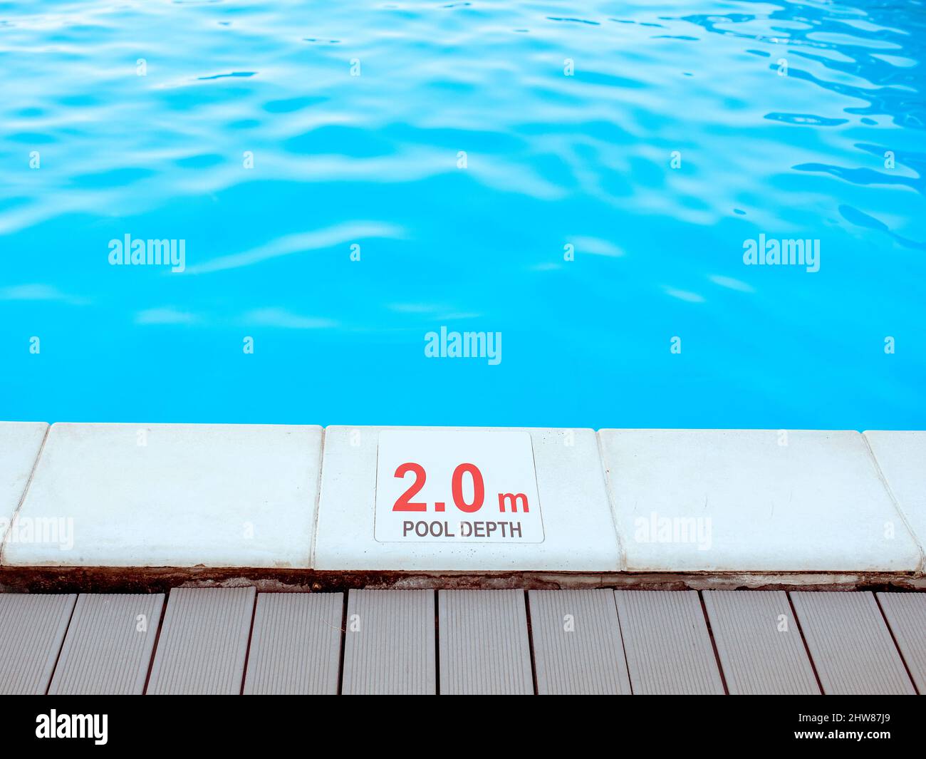 The edge of the swimming pool with the table with information of the ...