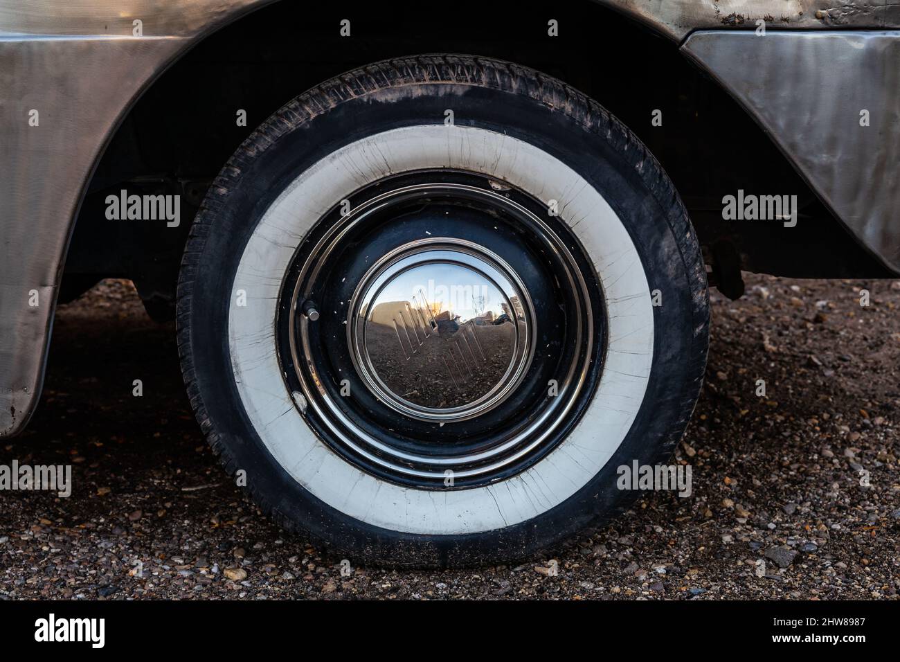 The white wall tire of a classic car that is slightly weathered in ...