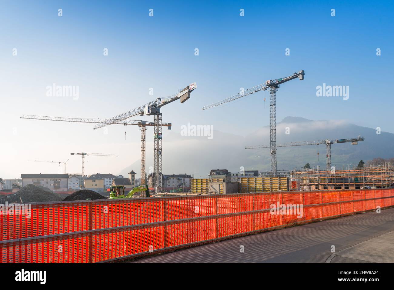 On the construction of houses several cranes. Barrier safety net around ...