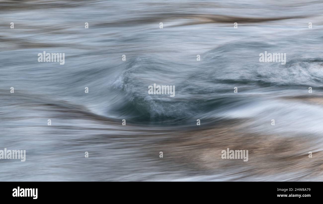Silky water surface detail from rapid mountain stream in long exposure ...