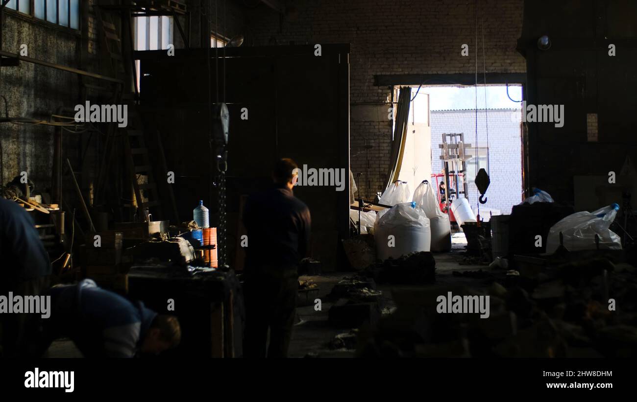 Workers work in old warehouse of plant. Stock footage. Factory workers ...