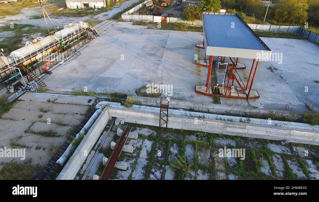 Oil pumps at the oil depot. Stock. Old tank farm on a Sunny day. Fuel ...