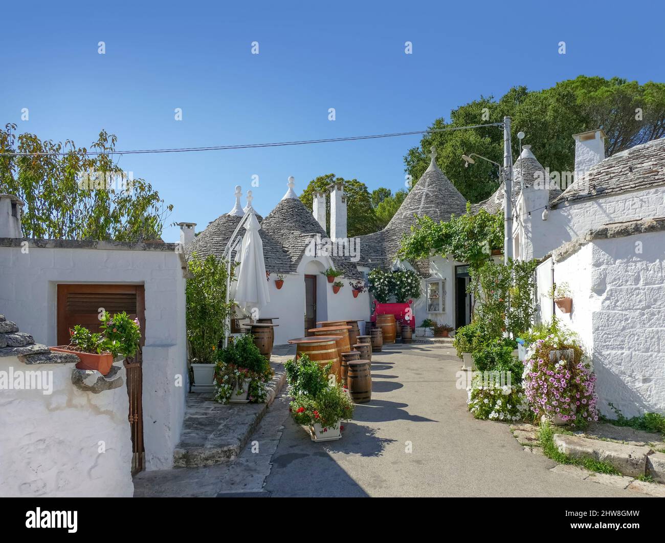 Sunny impression of trulli houses at a town named Alberobello in Apulia ...