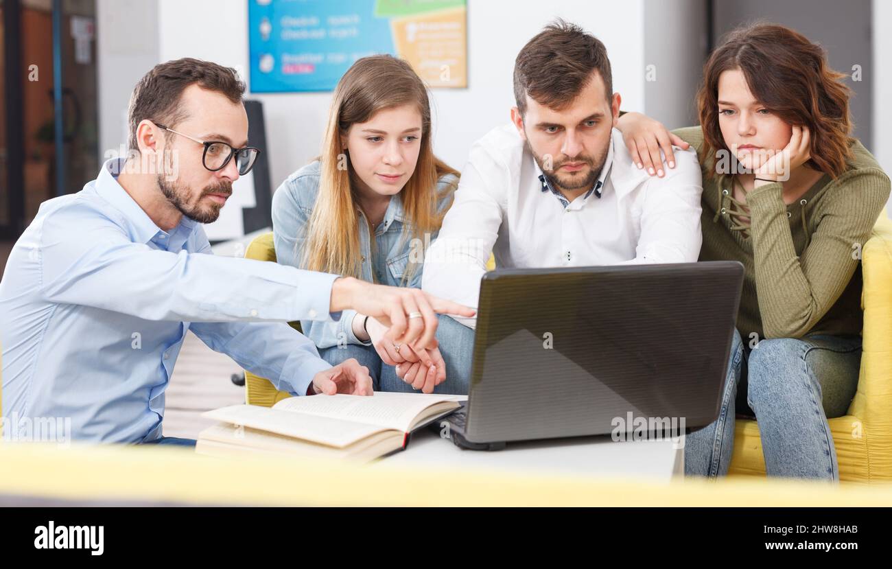 Young people with laptop Stock Photo - Alamy