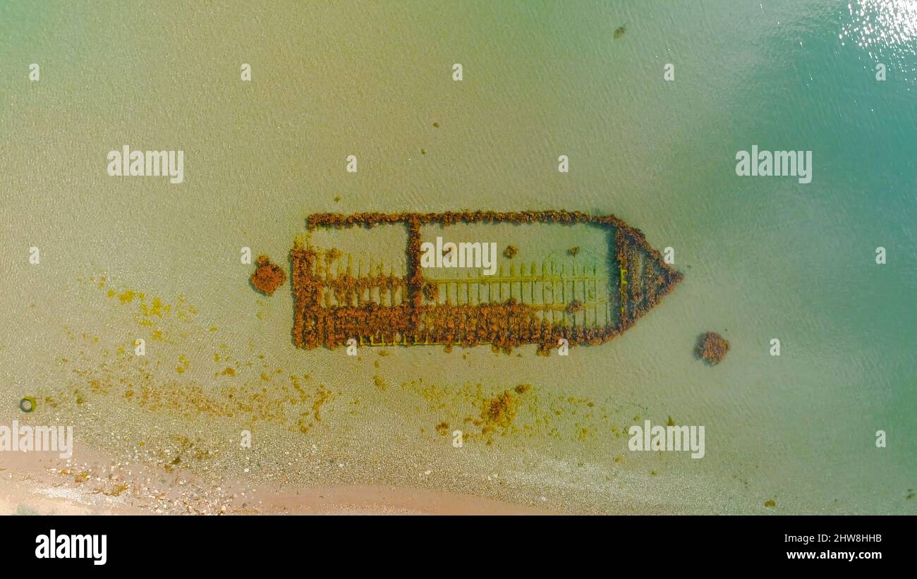 Overgrown sunken ship. Shot. Top view of sunken ship with algae. Sunken ...