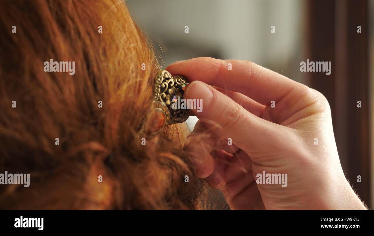 Vintage hairpin. Stock footage. Close-up of old hairpin inserted into ...