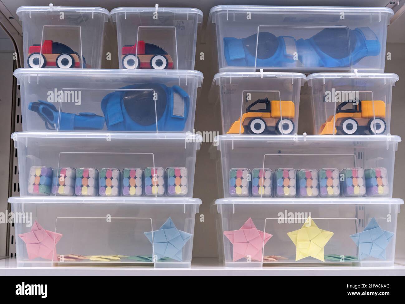 Transparent plastic containers with children's toys Stock Photo - Alamy