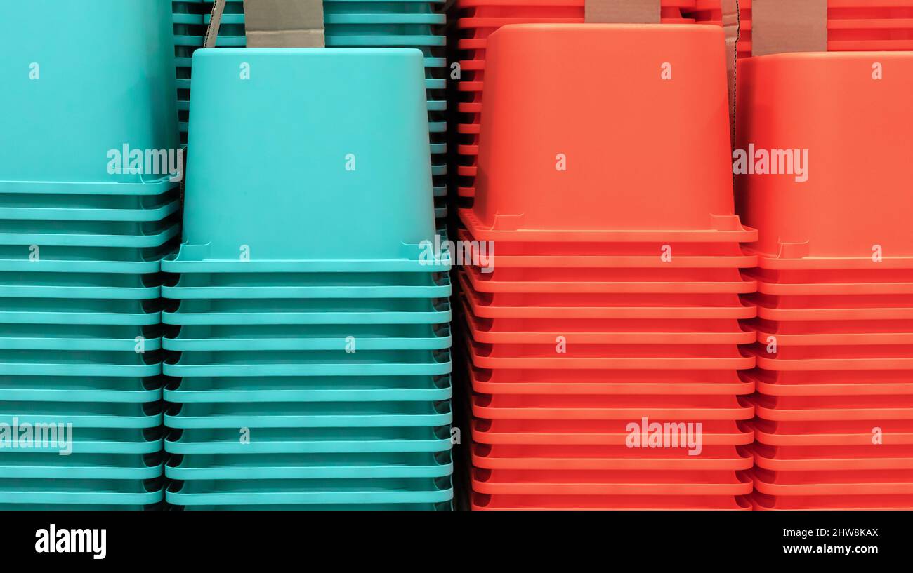 Stacks of multi-colored plastic containers for storing household items ...