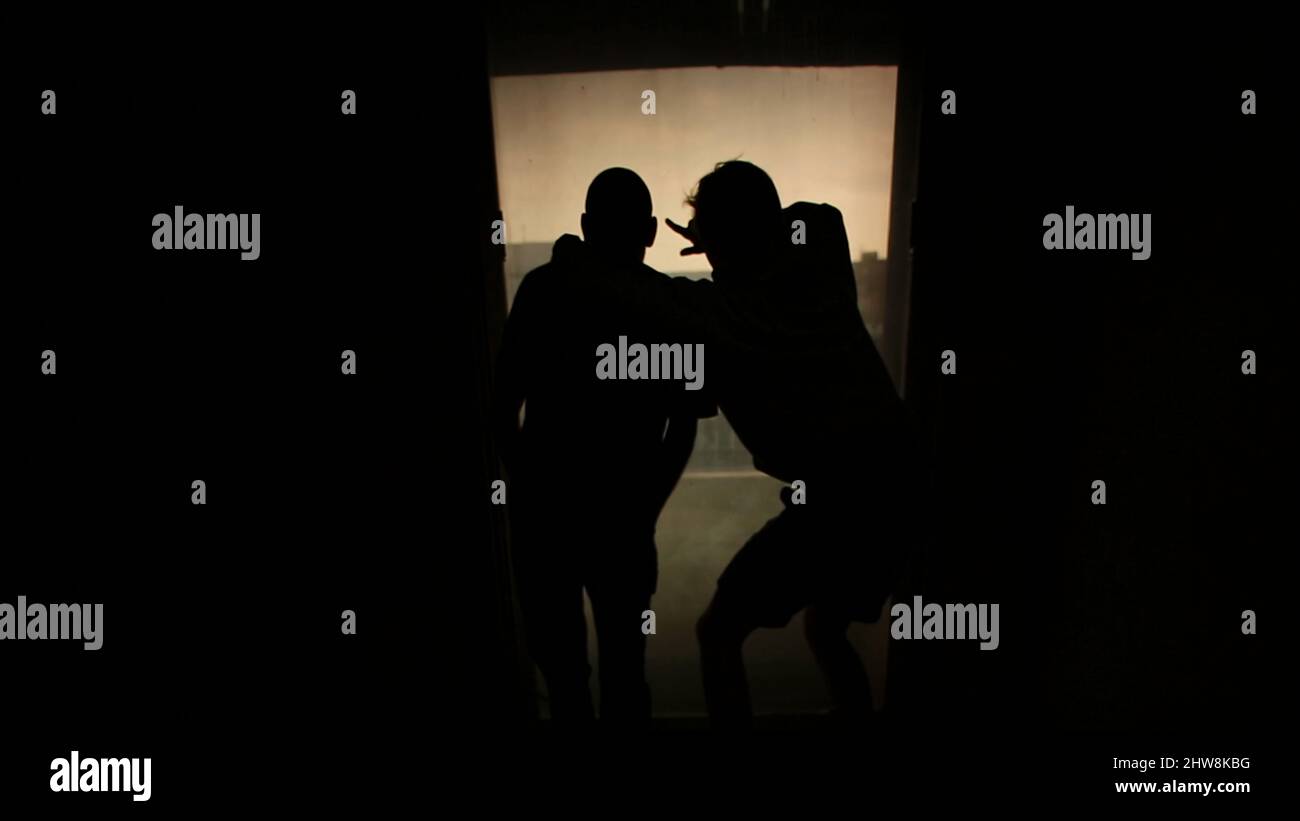 Silhouette of two other men looking out the window. Footage. Two ...