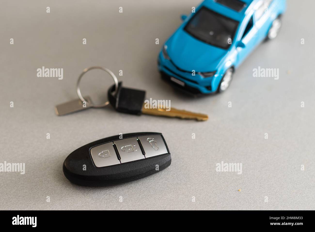 blue toy car with money and car key on wooden table Stock Photo - Alamy
