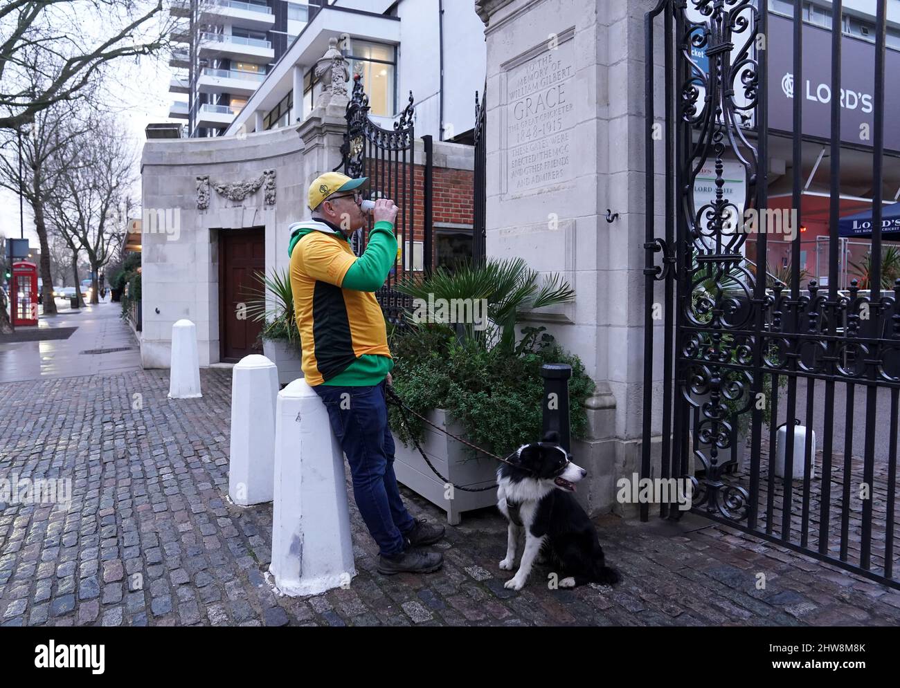 Derek Ford from Sydney, and his dog Rex, pay their respects at the ...