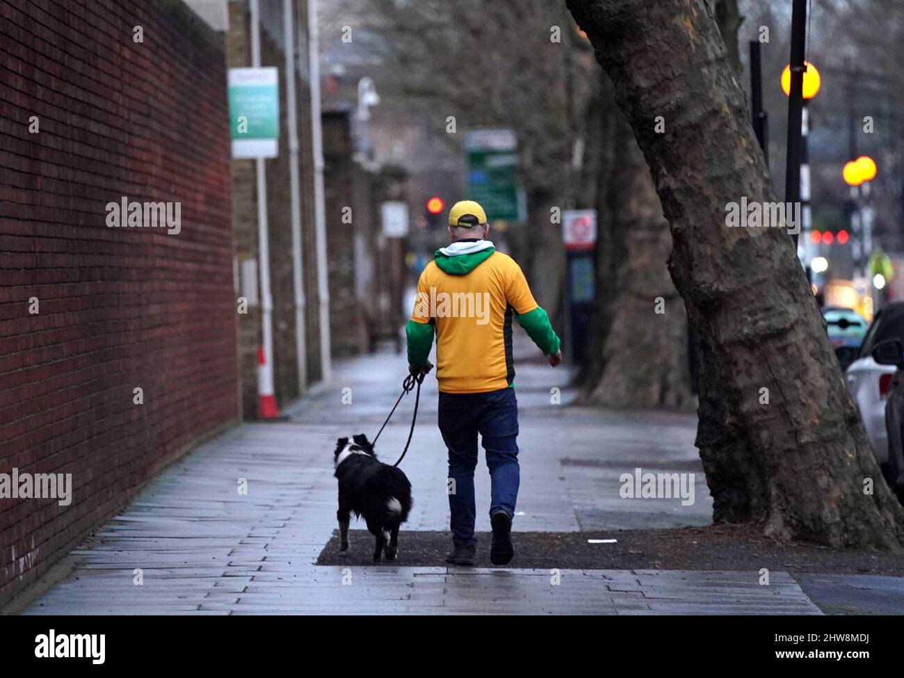 Derek Ford from Sydney, and his dog Rex, walk to pay their respects at ...