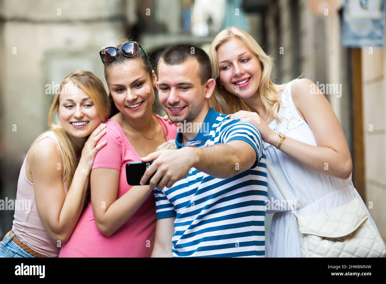 Four young cheerful persons taking self picture Stock Photo - Alamy