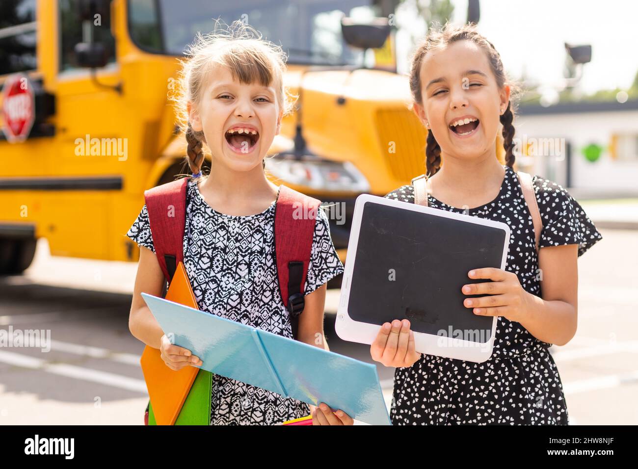 Two little kids going to school together Stock Photo - Alamy