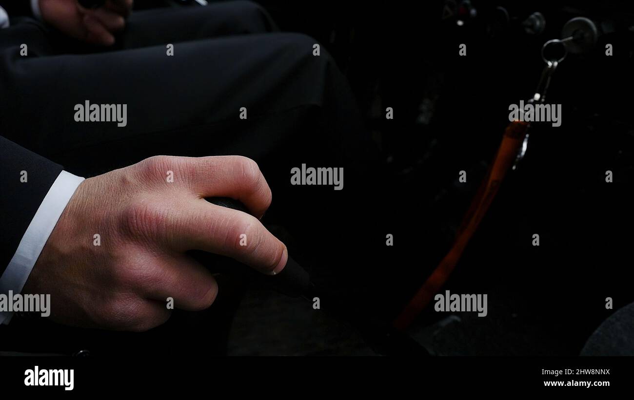 Businessman driving to work, hand shifting the gear stick. Businessman ...
