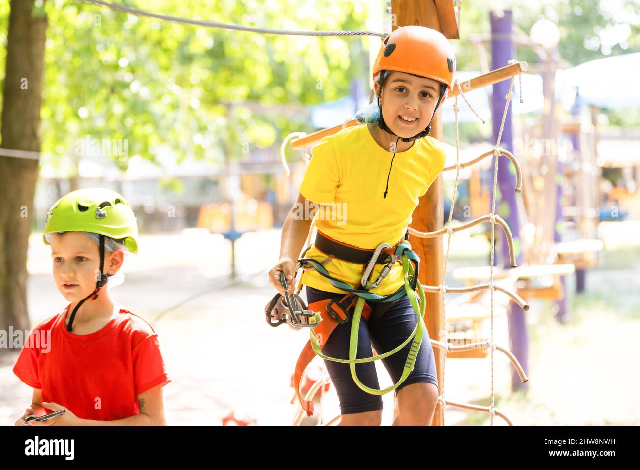 Happy child climbing in the trees. Rope park. Climber child. Early ...