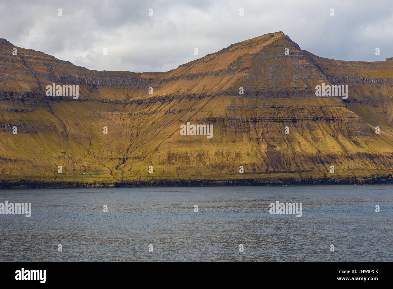 Steep coast of the islands of Kunoy and Kalsoy. Volcanic archipelago in ...