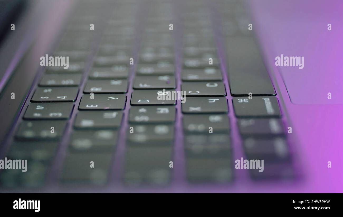 Side view of laptop or computer details, black keyboard with white ...