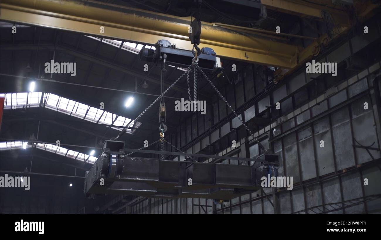 Frame of train on plant. Clip. Platform with train wheels is suspended ...
