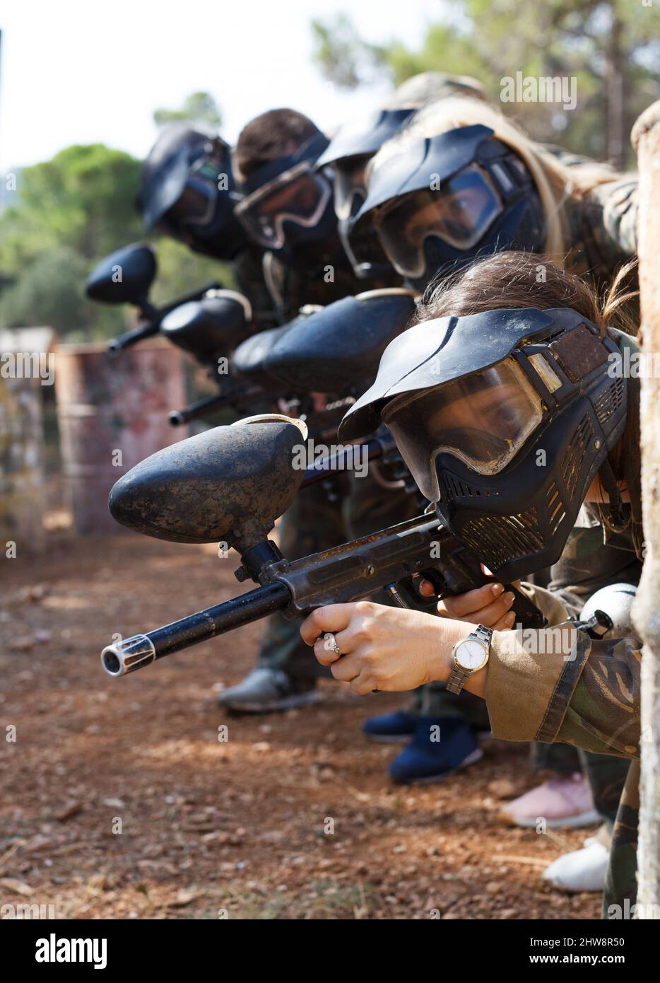 Paintball players aiming with gun in shootout outdoors Stock Photo - Alamy