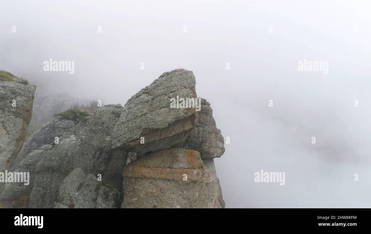 Slope of mountain in mist. Shot. Dense gray fog envelops entire space ...