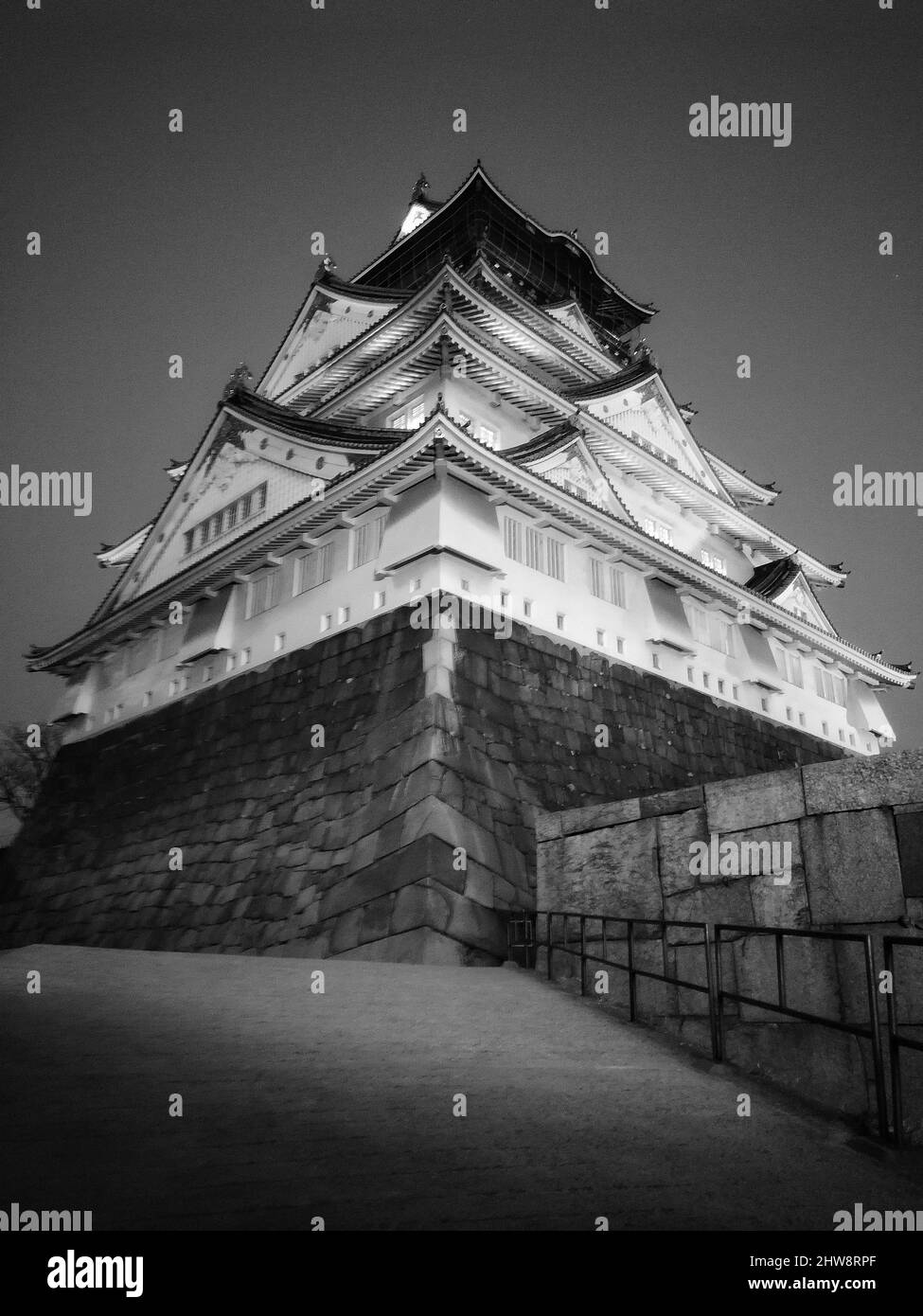 Vertical low angle shot of the Osaka castle in black and white in Japan ...