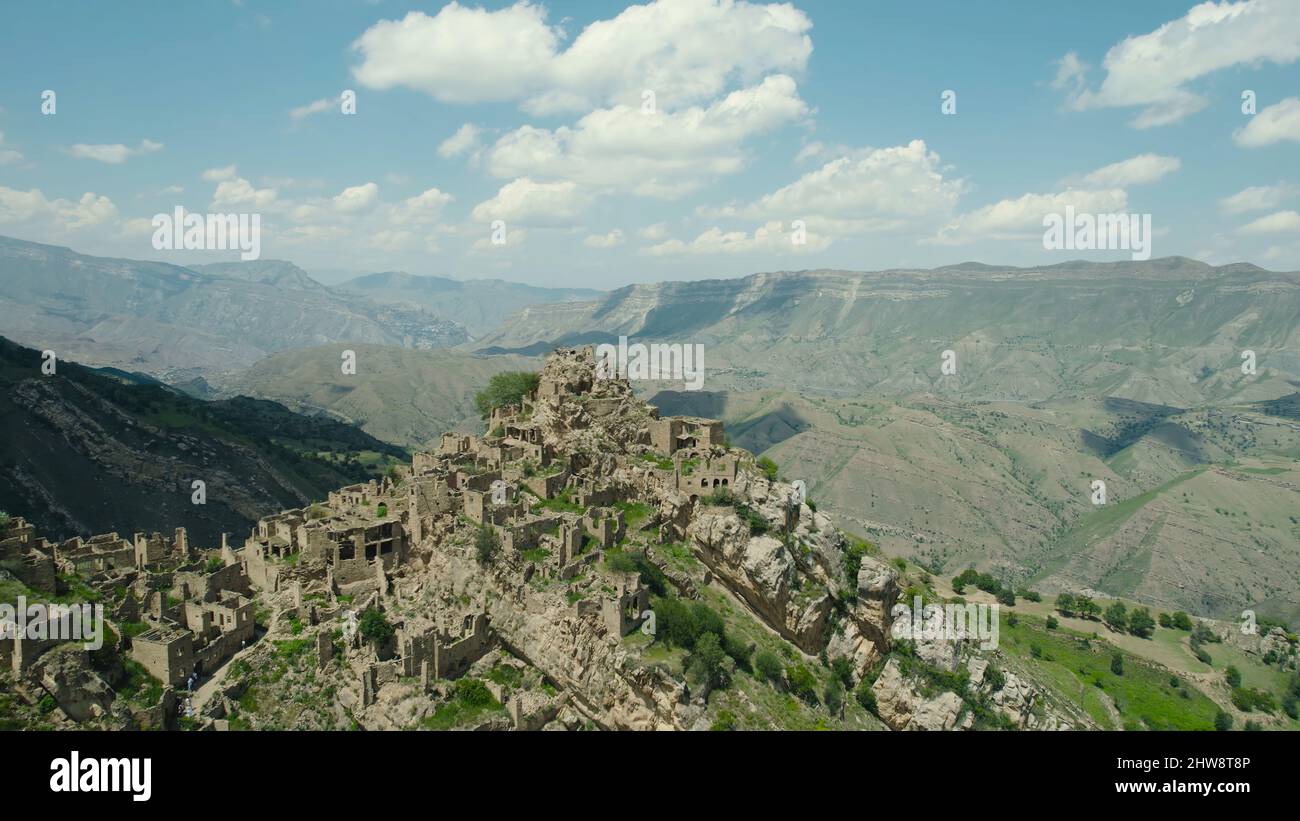 Ancient stone city on rock on background of mountains. Action. Amazing ...