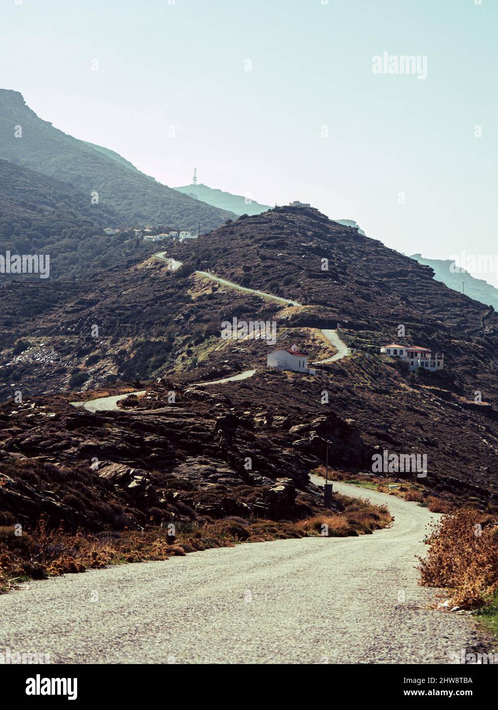 Beautiful view of a road on a hill with rocks under the clear sky Stock ...