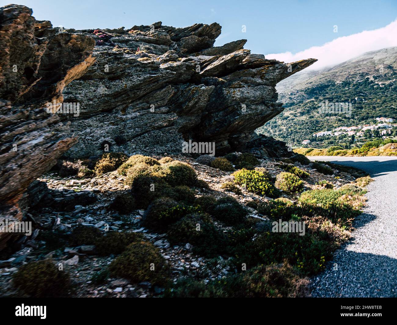 Beautiful view of a road on a hill with rocks under the clear sky Stock ...