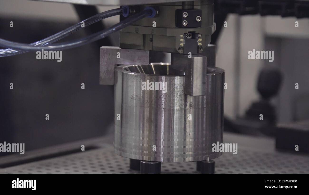 Industrial robot arm in factory. Robotic arm moves metal details in the ...