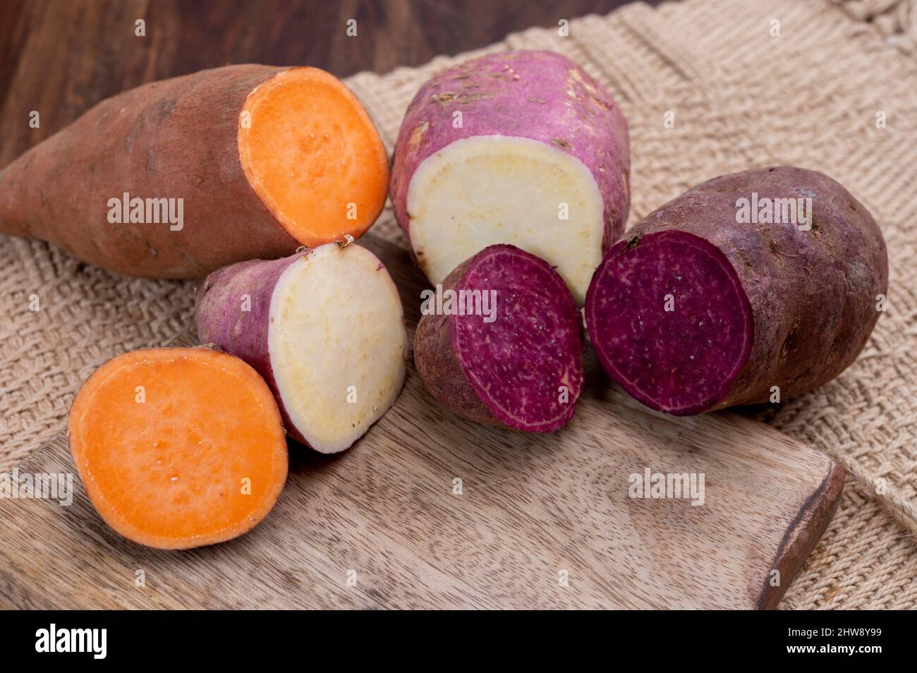Colorful root vegetables pink, purple and orange organic sweet potatos ...