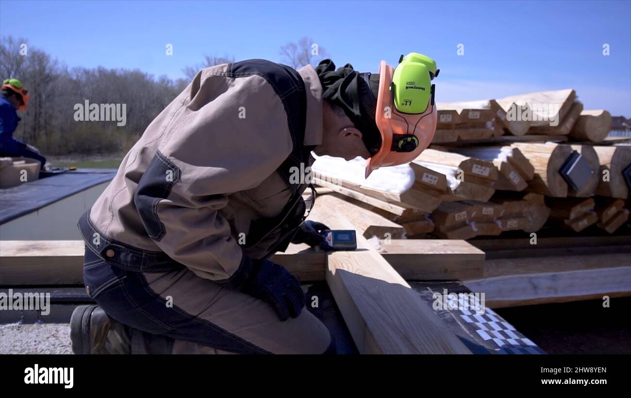 Working makes measurements with special device. Clip. Builder in shape ...