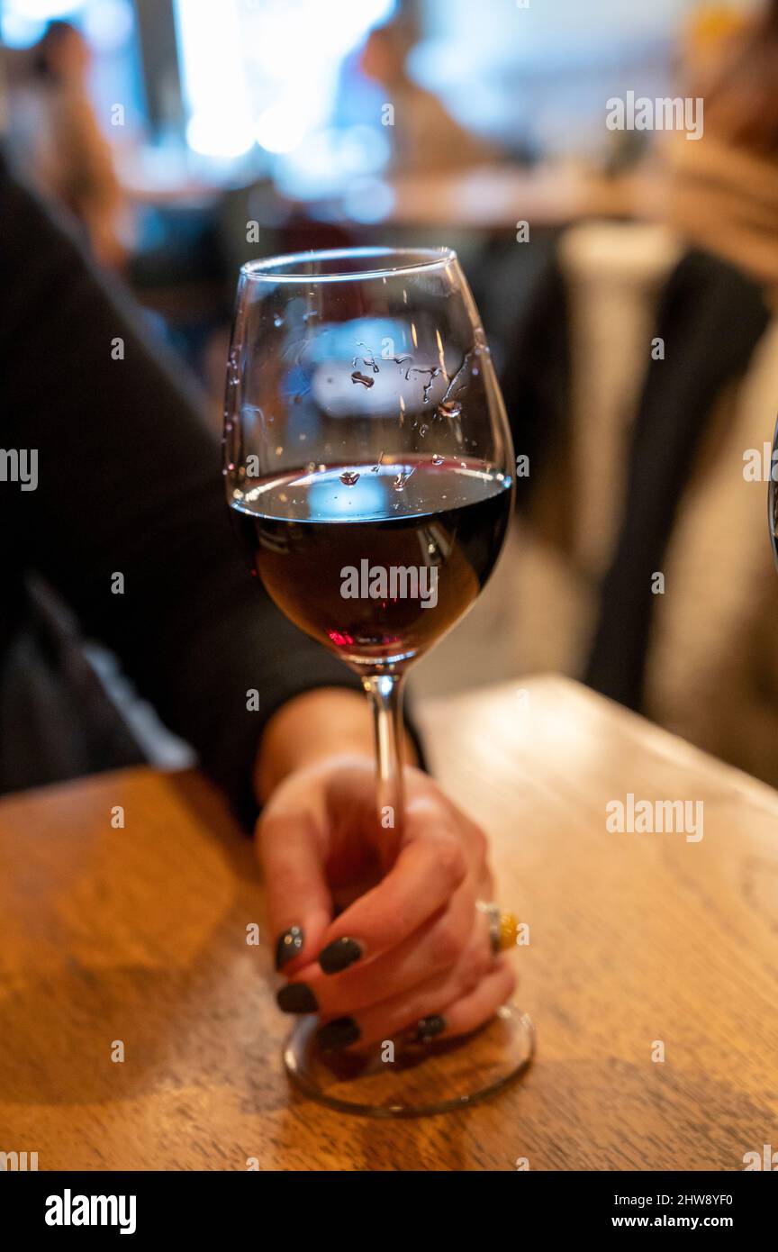 Tasting of dry Italian primitivo red wine in Italian cantina restaurant ...