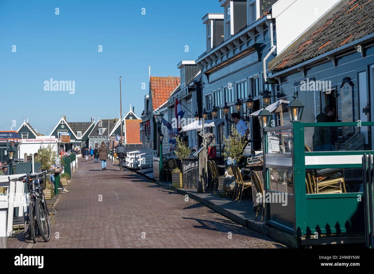 Walking on sunny spring day in small Dutch town Marken with wooden ...