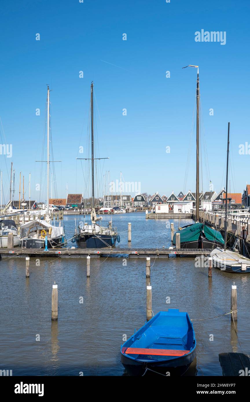 Walking on sunny spring day in small Dutch town Marken with wooden ...