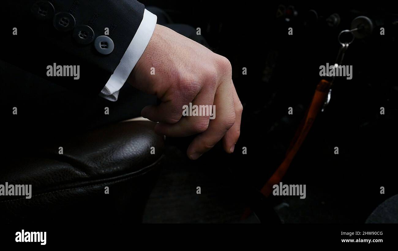 Businessman driving to work, hand shifting the gear stick. Businessman ...