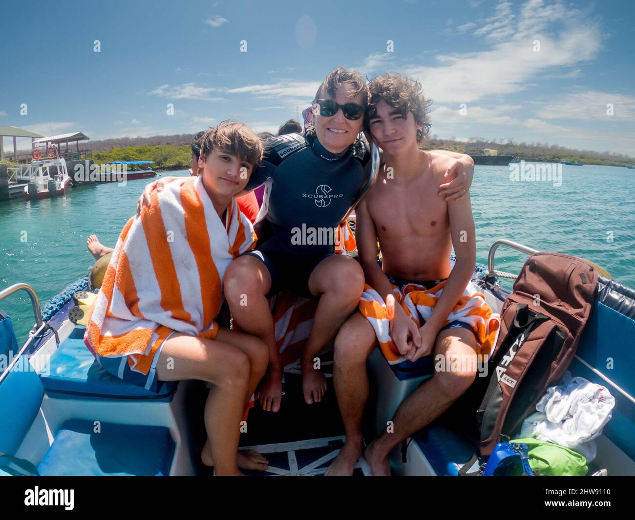 Mother and two teenage sons dry off after snorkelling off Santa Cruz ...