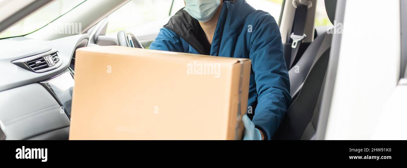 Delivery driver driving with parcels on seat Stock Photo - Alamy
