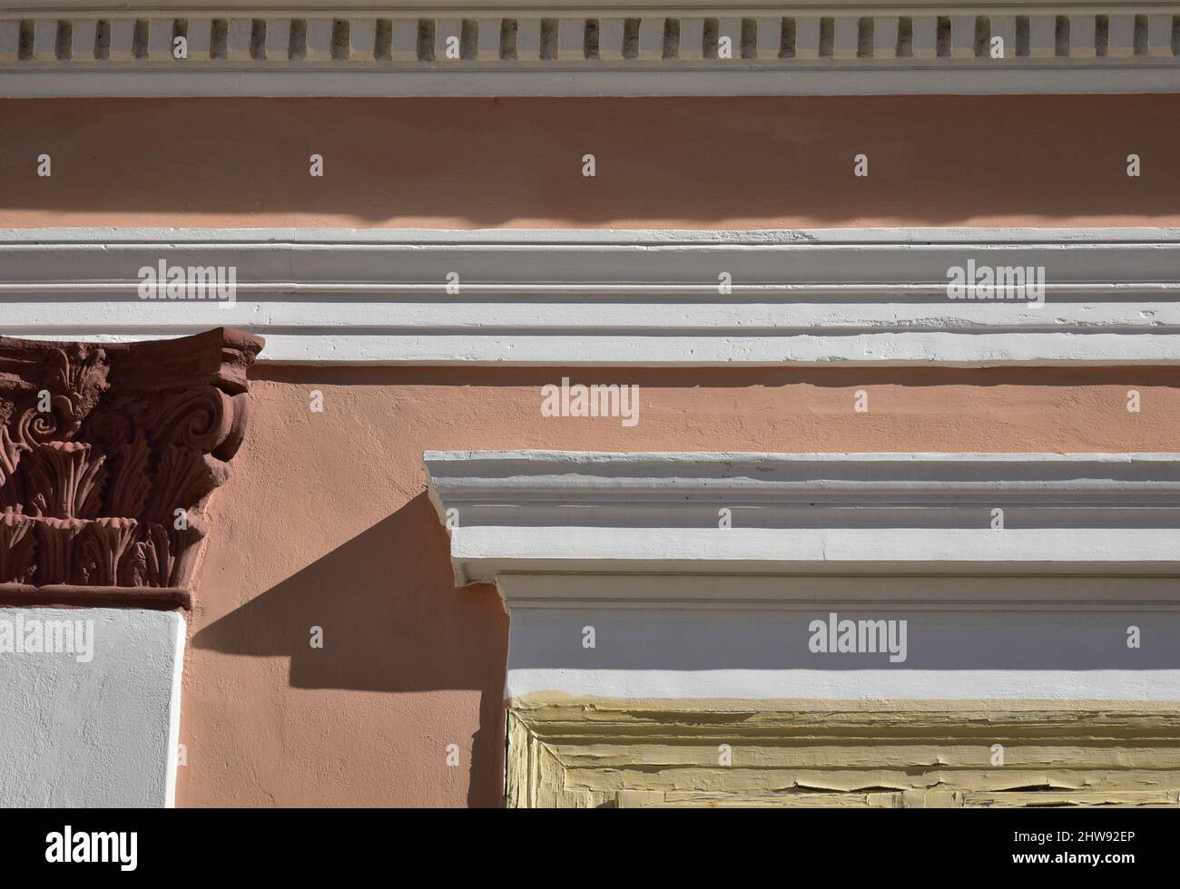 Old Neoclassical house facade with an ochre stucco wall, Ionic order ...