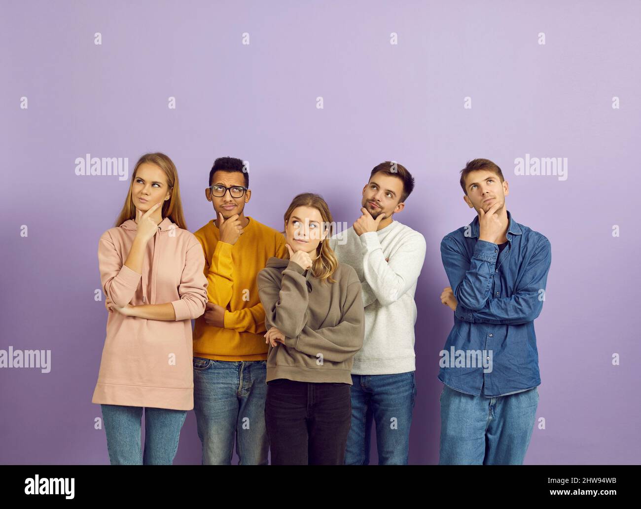 Diverse group of puzzled people thinking about problem or doubting ...