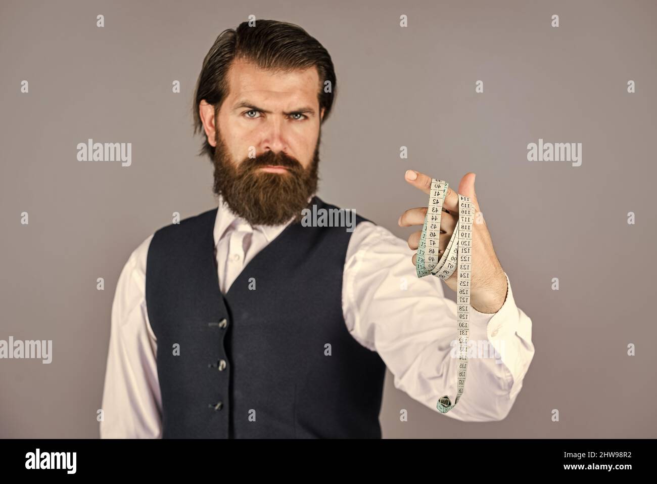 Talented tailor. man tailor with tape measure and scissors. man ...