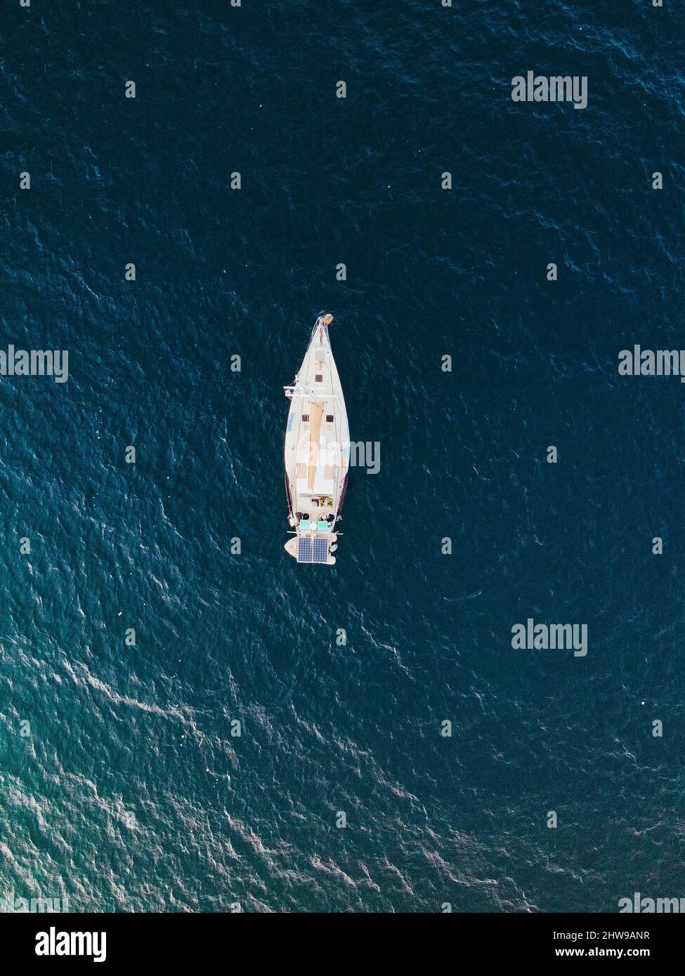 Mesmerizing aerial scene of a speed white boat in the dune blue sunny ...