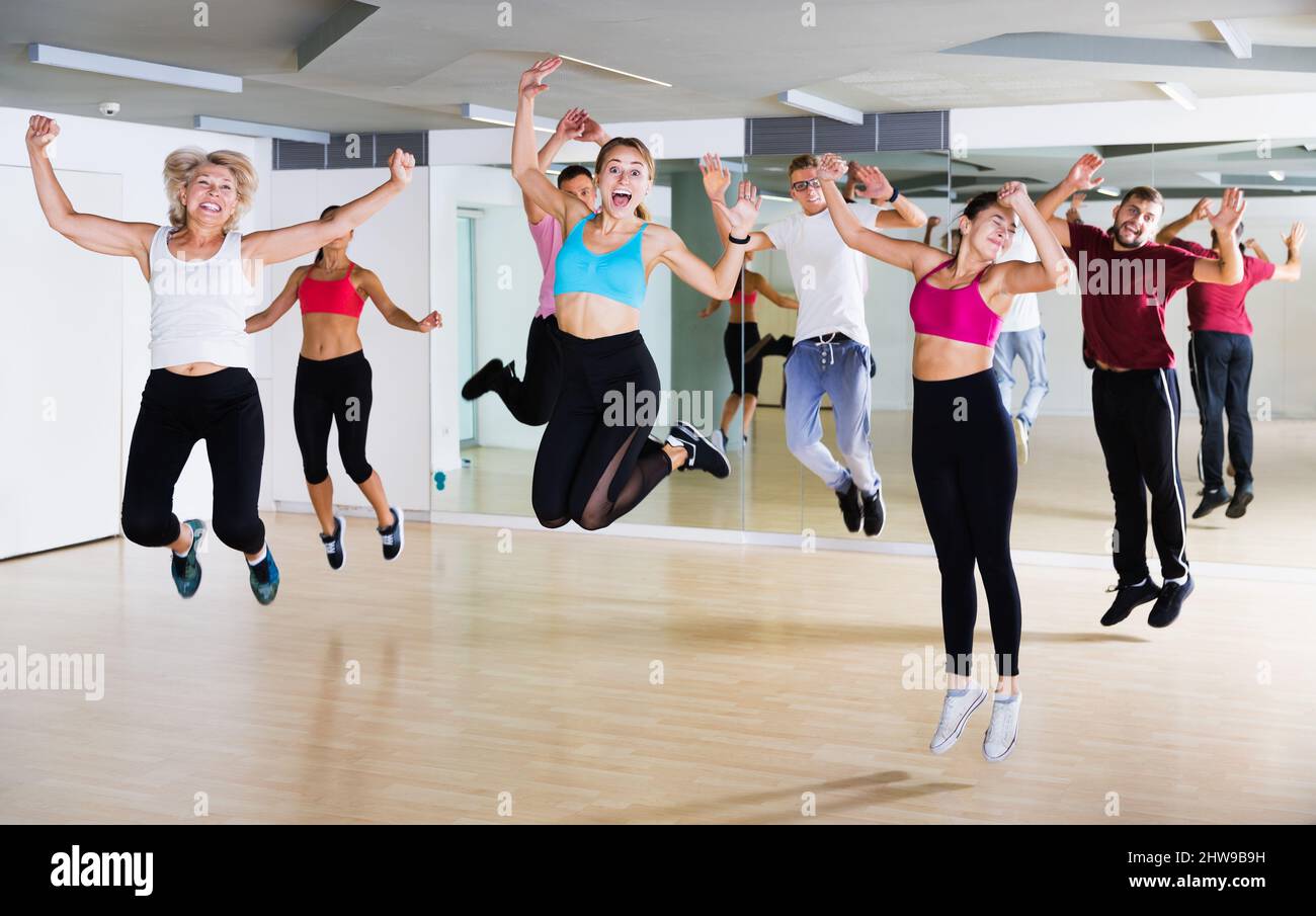Adults jumping at dance class Stock Photo - Alamy