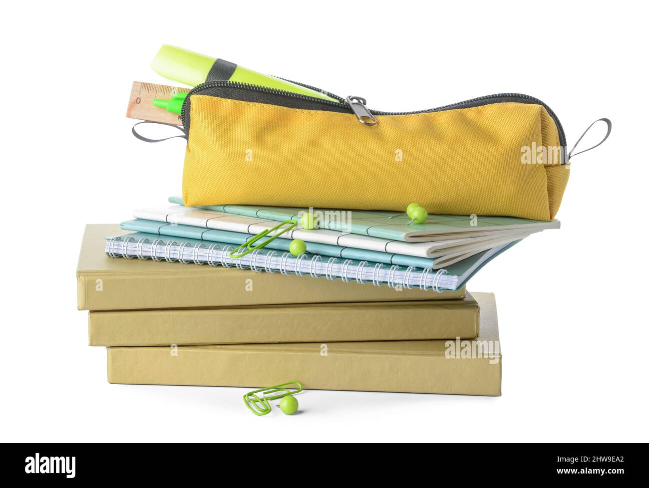 Stack of books, notebooks and pencil case with stationery on white ...