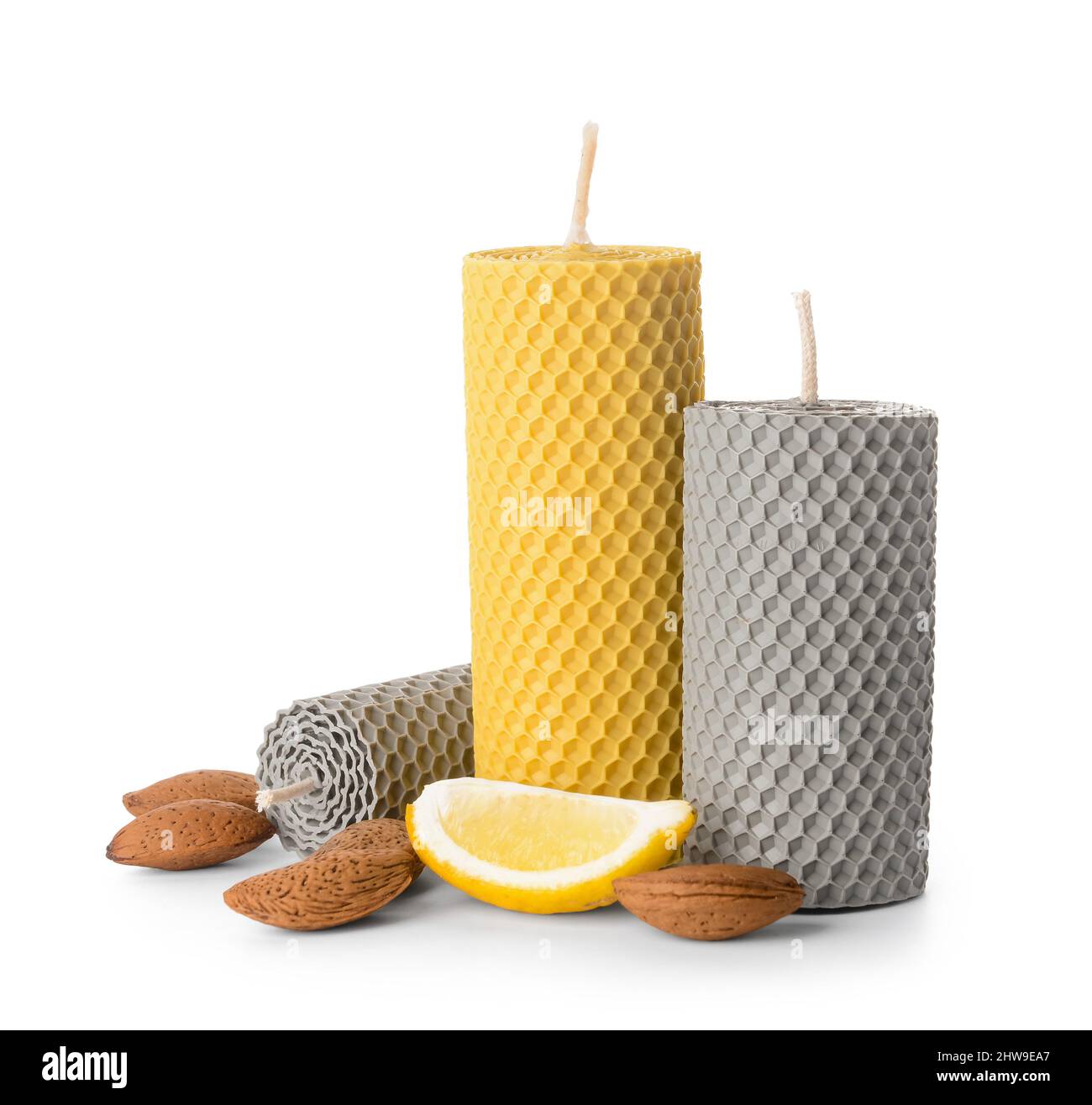 Wax candles, almond nuts and lemon slice on white background Stock ...