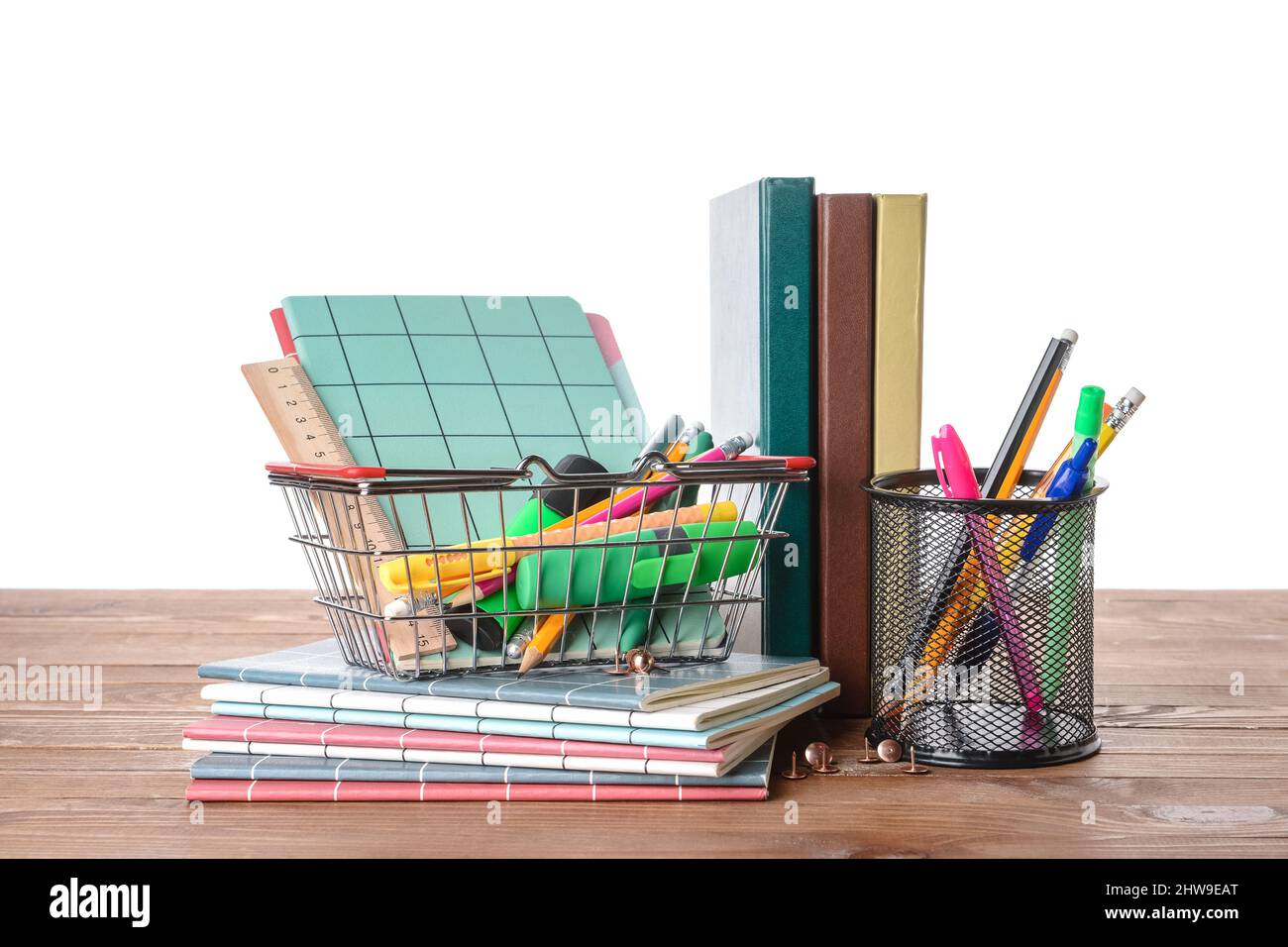 Set of different stationery on wooden table against white background ...