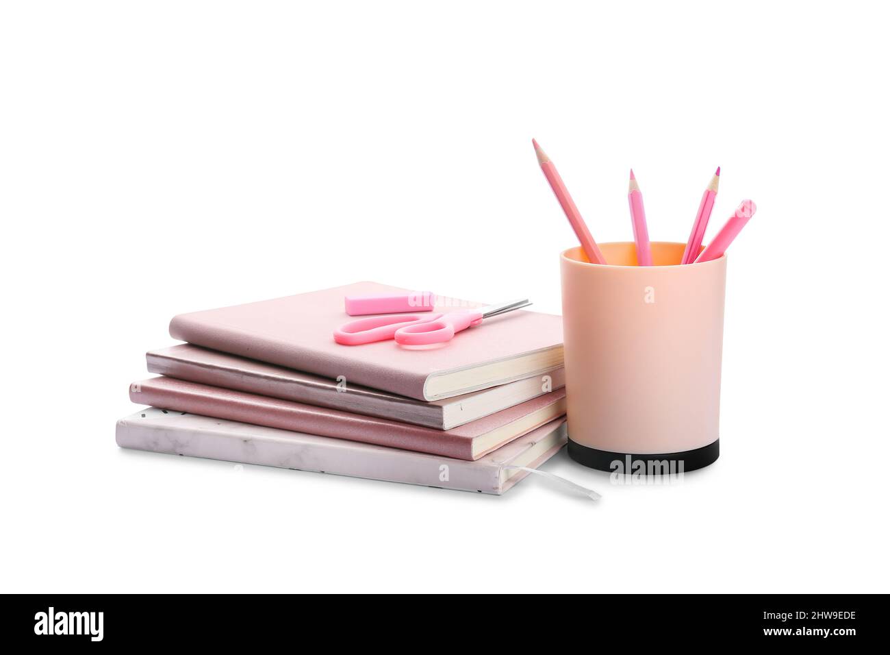 Stack of notebooks, scissors, eraser and pencils on white background ...