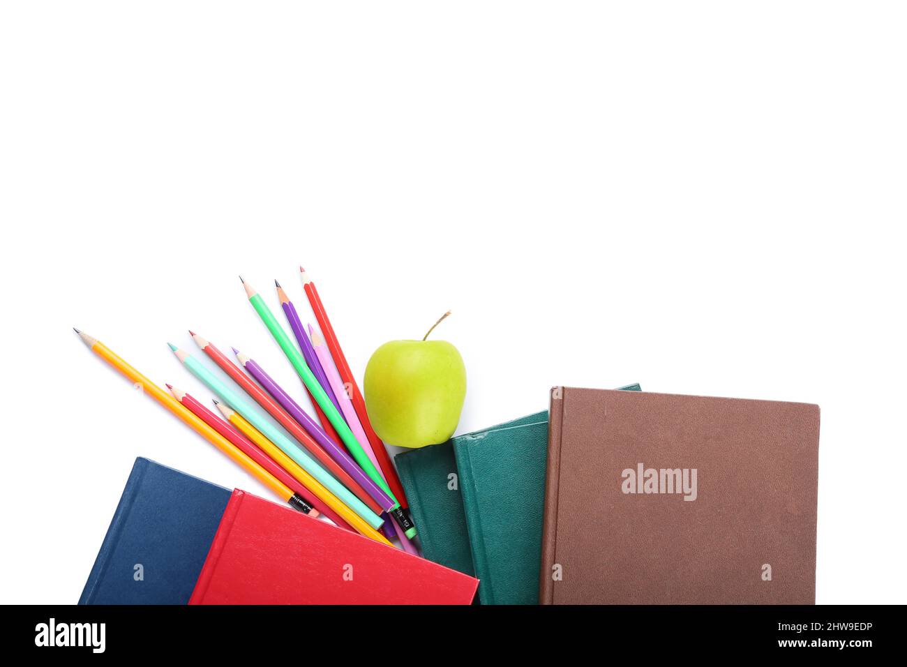 Different notebooks, color pencils and apple on white background Stock ...