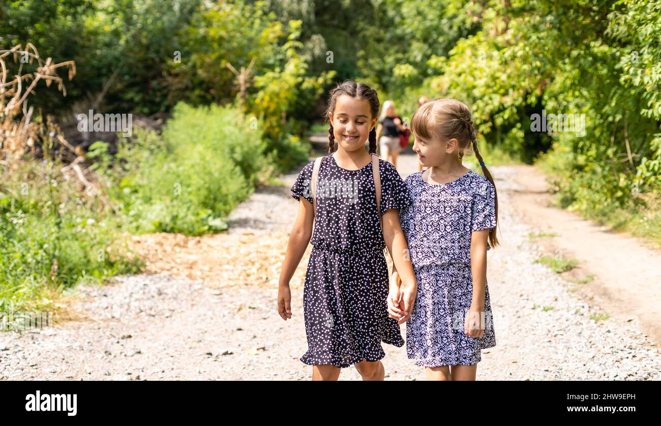 Portrait of two girls with school bags after lesson in school Stock ...